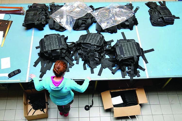 To save a life: Refugees make protective vests for Ukraine | The Asian ...